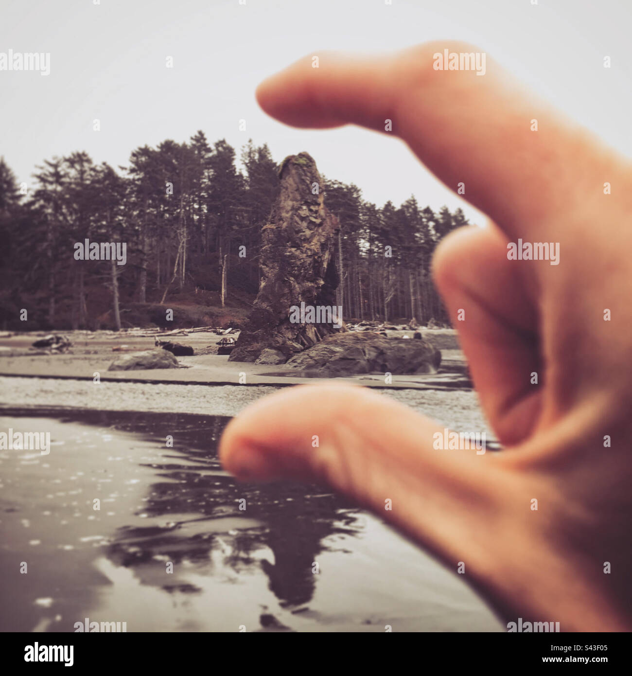 Measuring the size of rock formation with thumb and index finger Stock ...