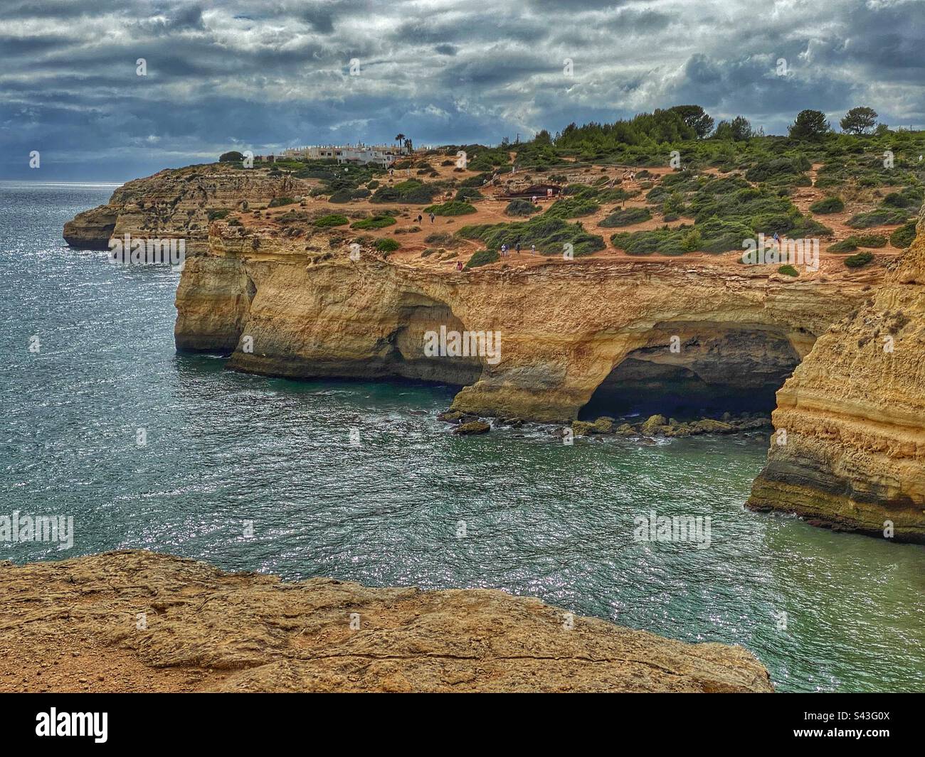Sea view with sandstone formations and arch in the cliffs of Algarve ...