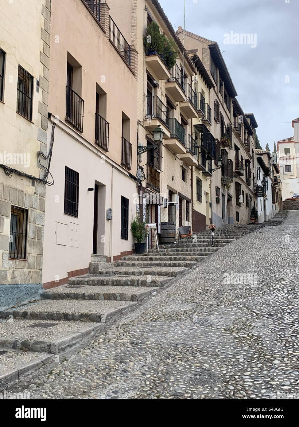 Cobbled street in Granada Spain Stock Photo - Alamy
