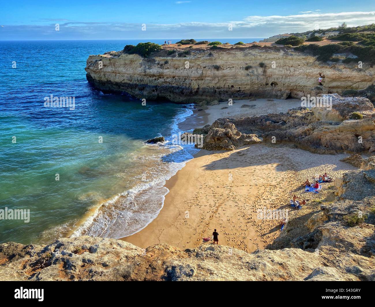 High-angle seascape view at Albandeira beach with sandstone rocks in ...