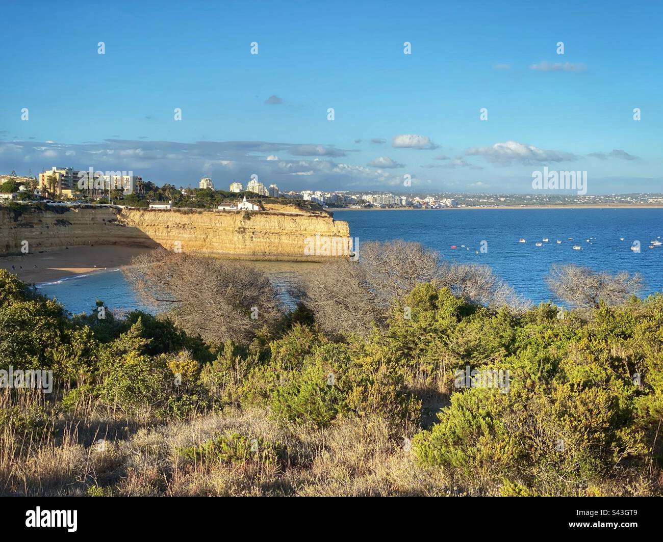 Scenic view with little white Senhora da Rocha church on the cliff and ...