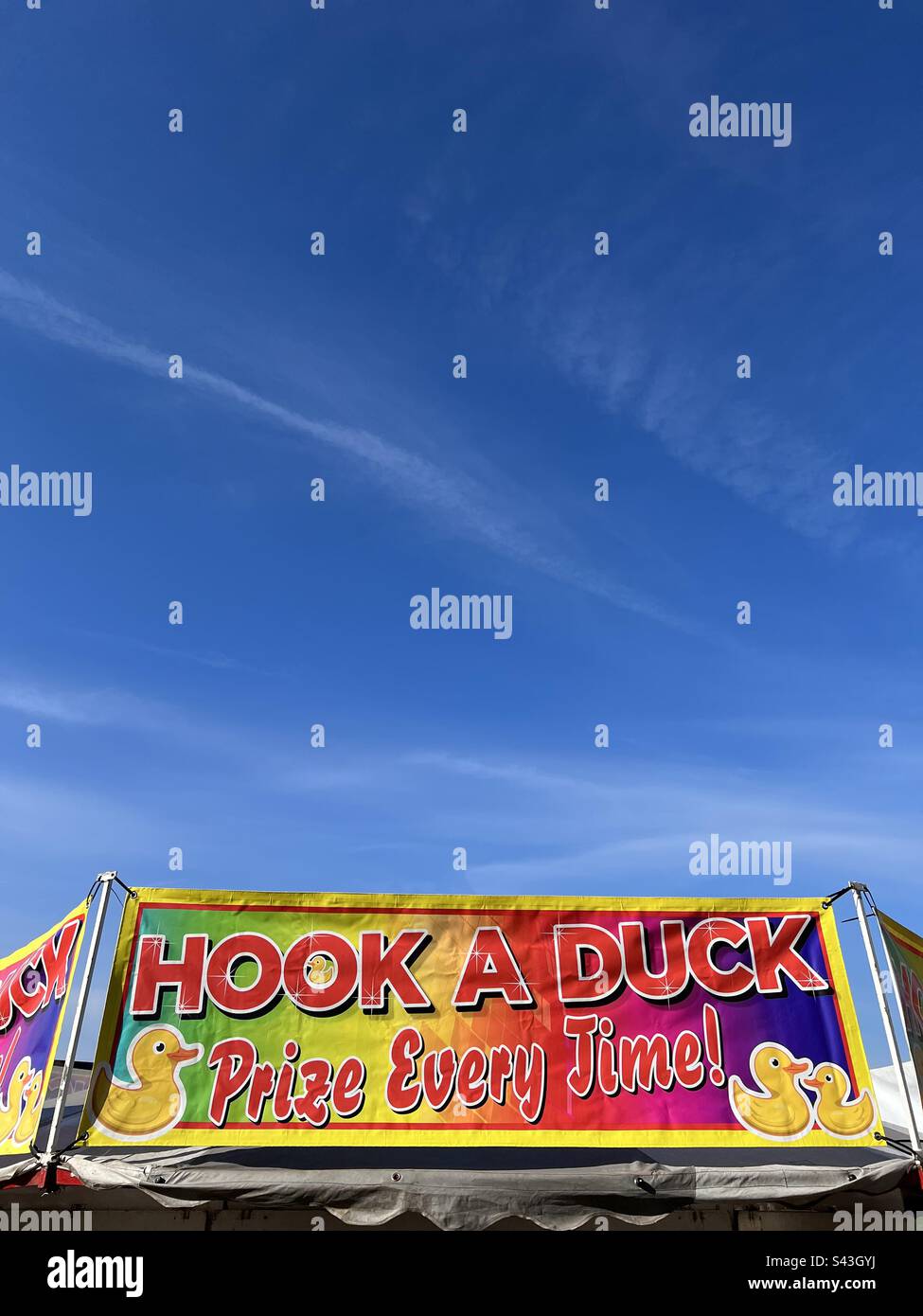 Hook a Duck fairground attraction. Sign against a blue sky Stock Photo ...