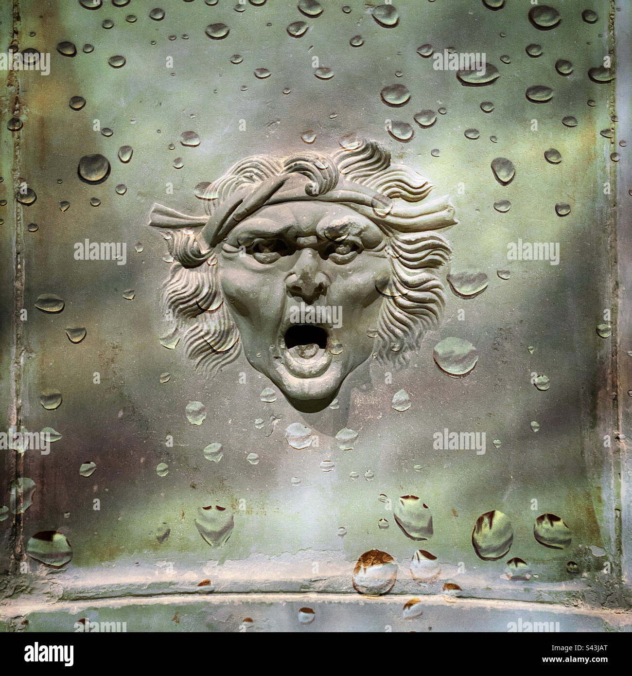 Angry face waterspout on an ancient Roman fountain Stock Photo - Alamy