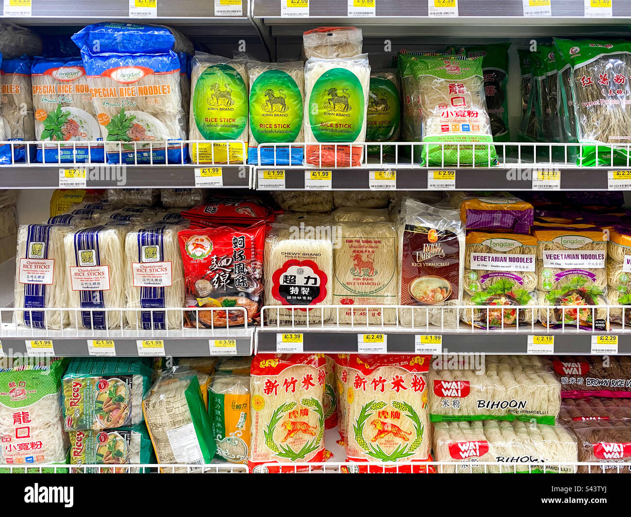 Packets of dried noodles on shelves in an Asian supermarket in London ...
