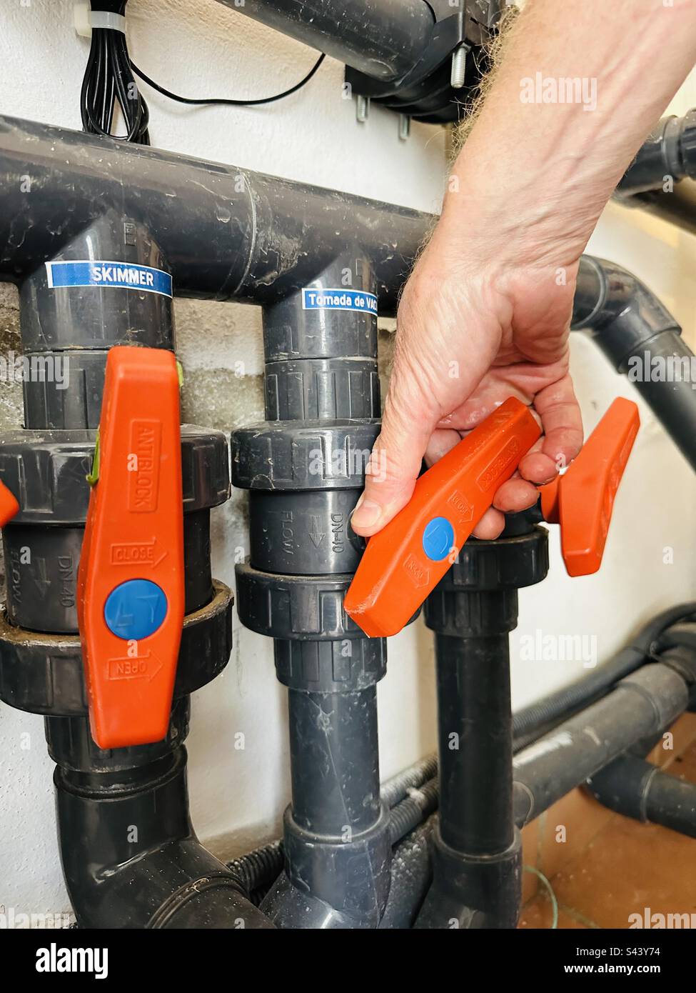 Operating the pool valve for a private swimming pool Stock Photo - Alamy