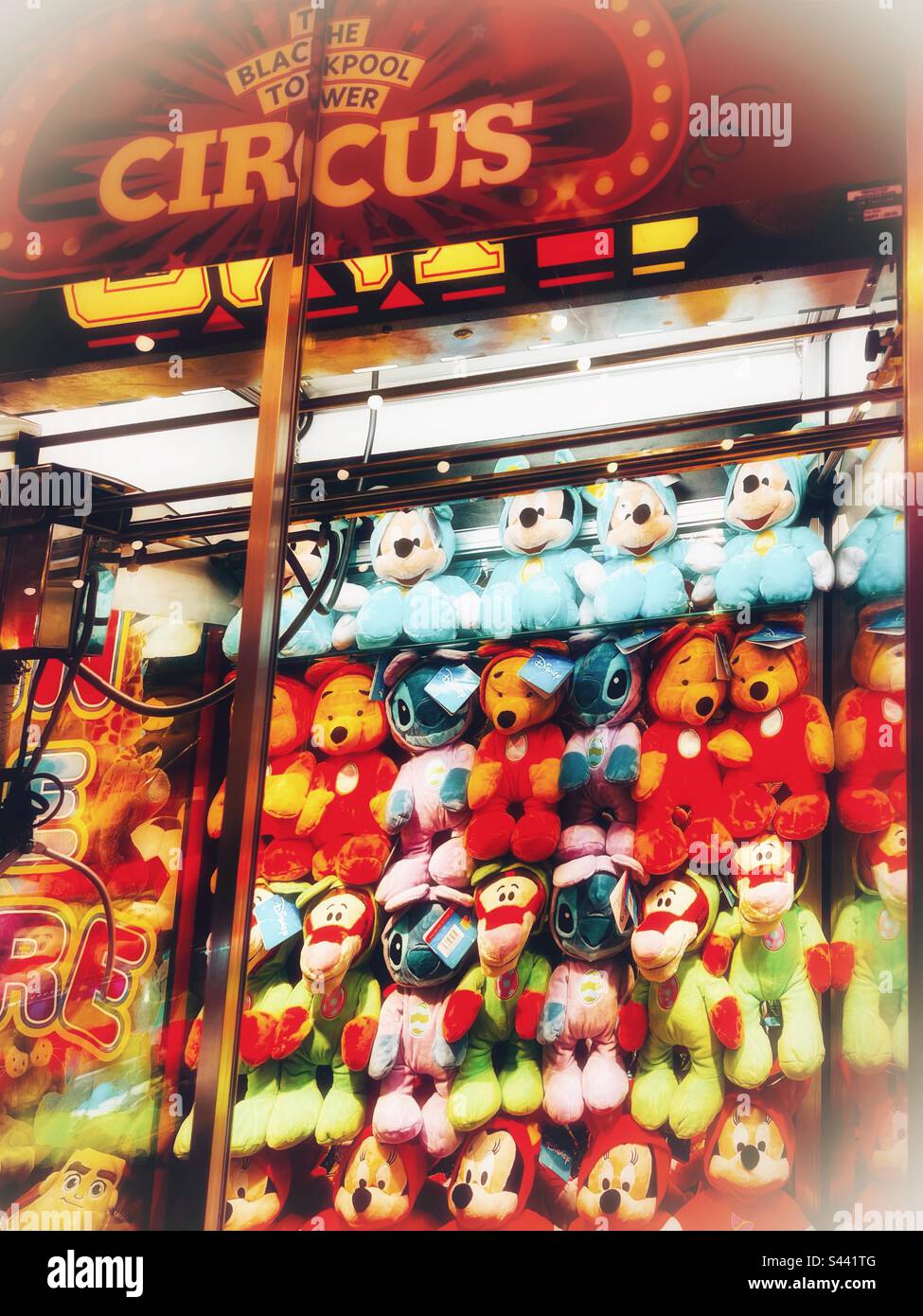 Claw machine arcade game with Winnie the pooh plush toys Stock Photo ...