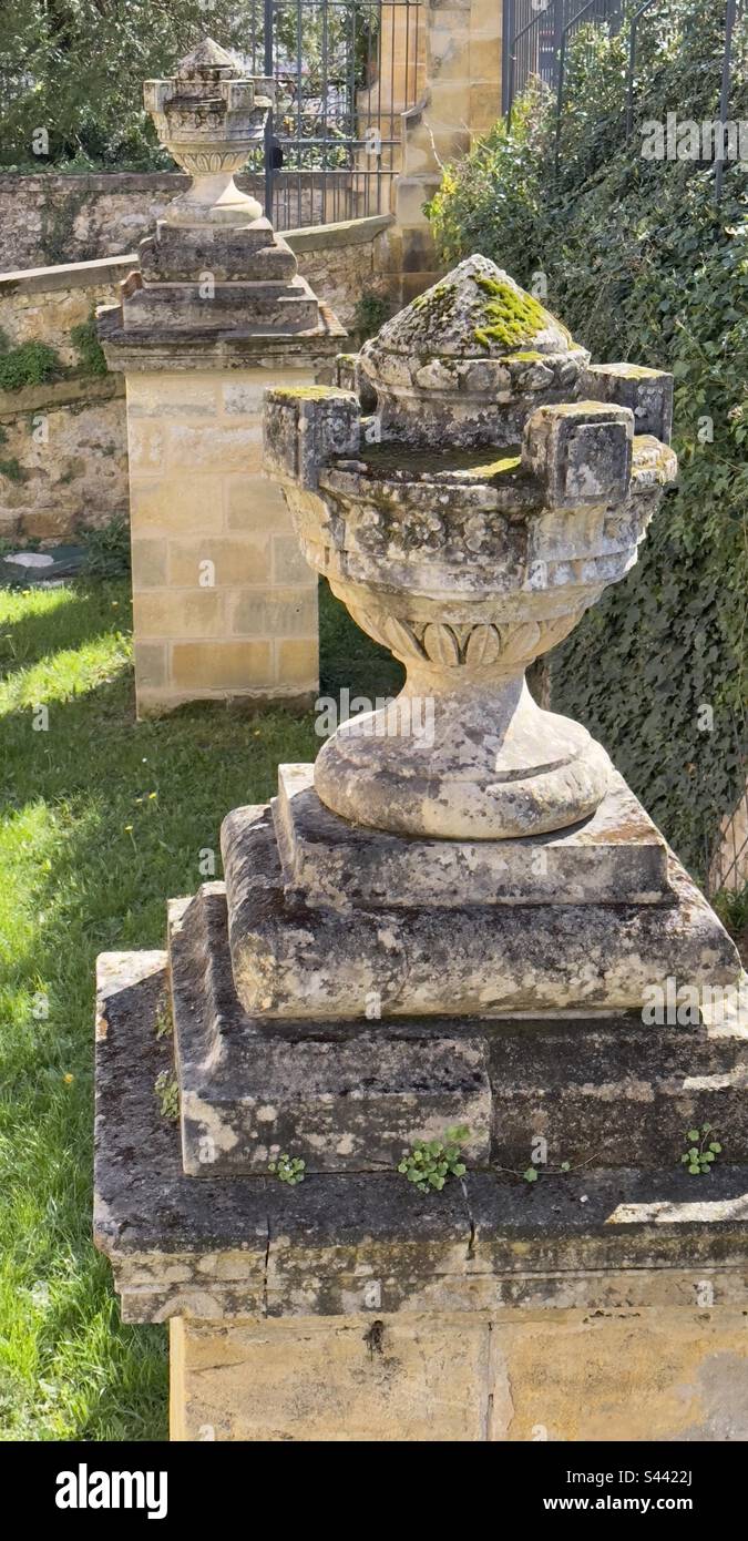 Two stone vases in the garden of a French hotel Stock Photo - Alamy