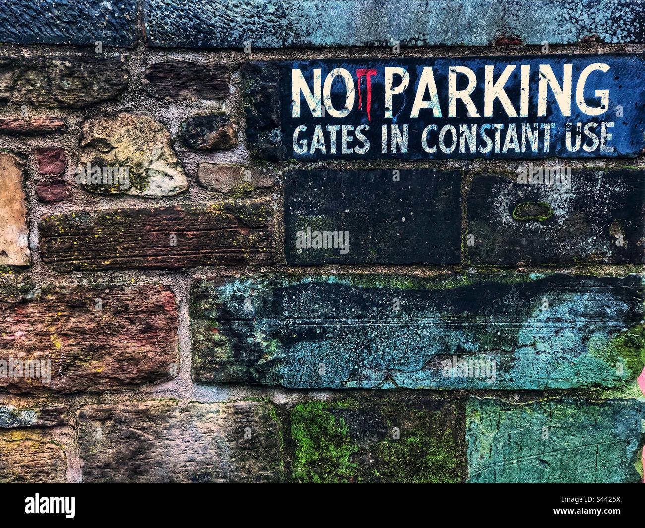 No parking sign on an old damp stone wall Stock Photo - Alamy