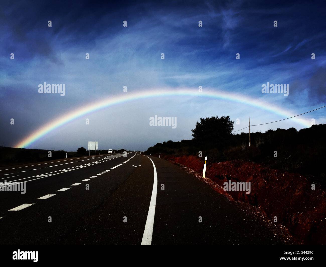 Rainbow across th road Stock Photo - Alamy