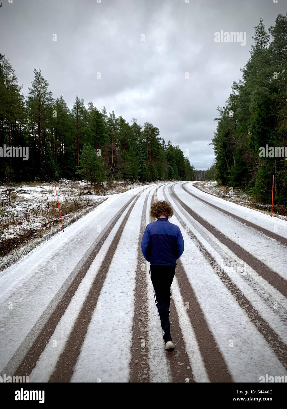 Boy Walking Alone On Road