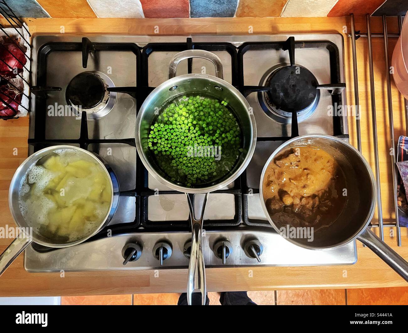 Cooking on gas stove hi-res stock photography and images - Alamy