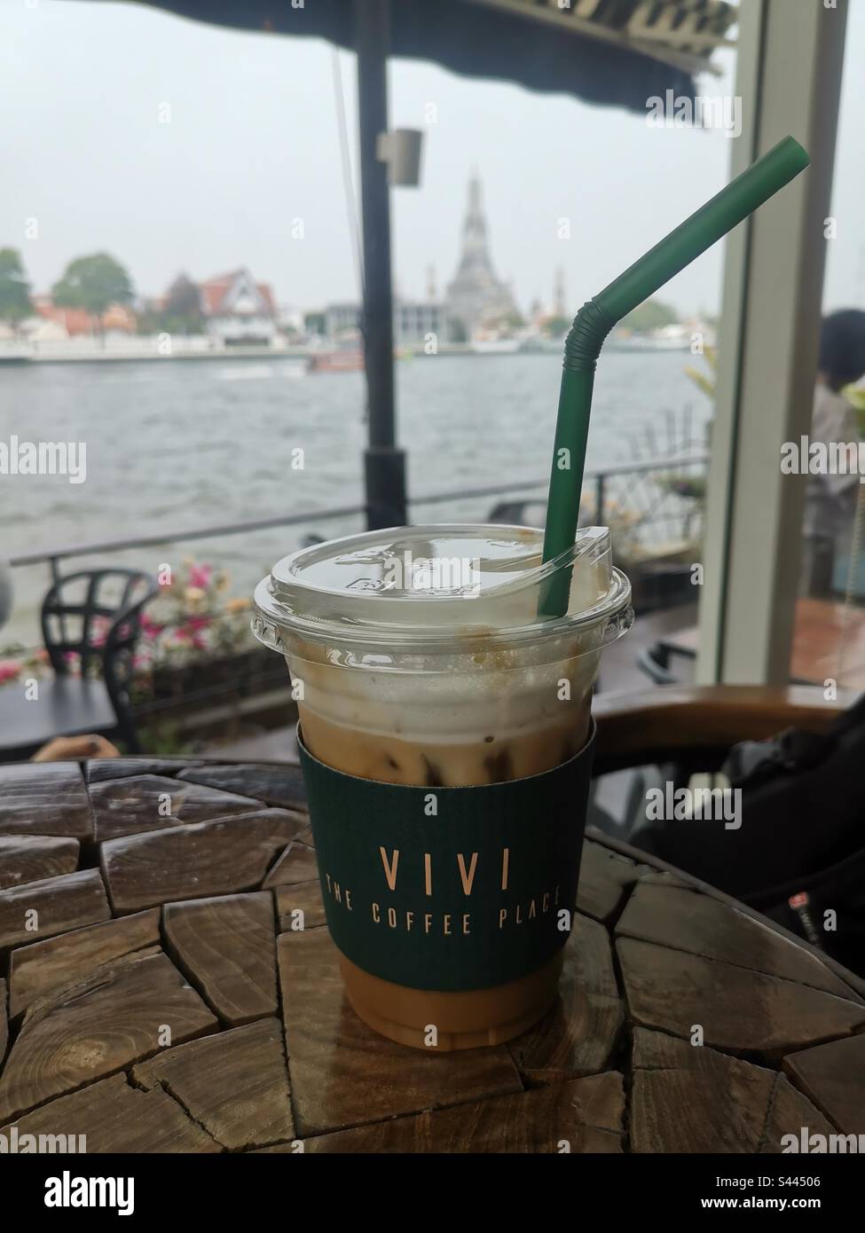 Drinking Ice coffee at Vivi cafe by the Chao Phraya river in Bangkok, Thailand Stock Photo - Alamy
