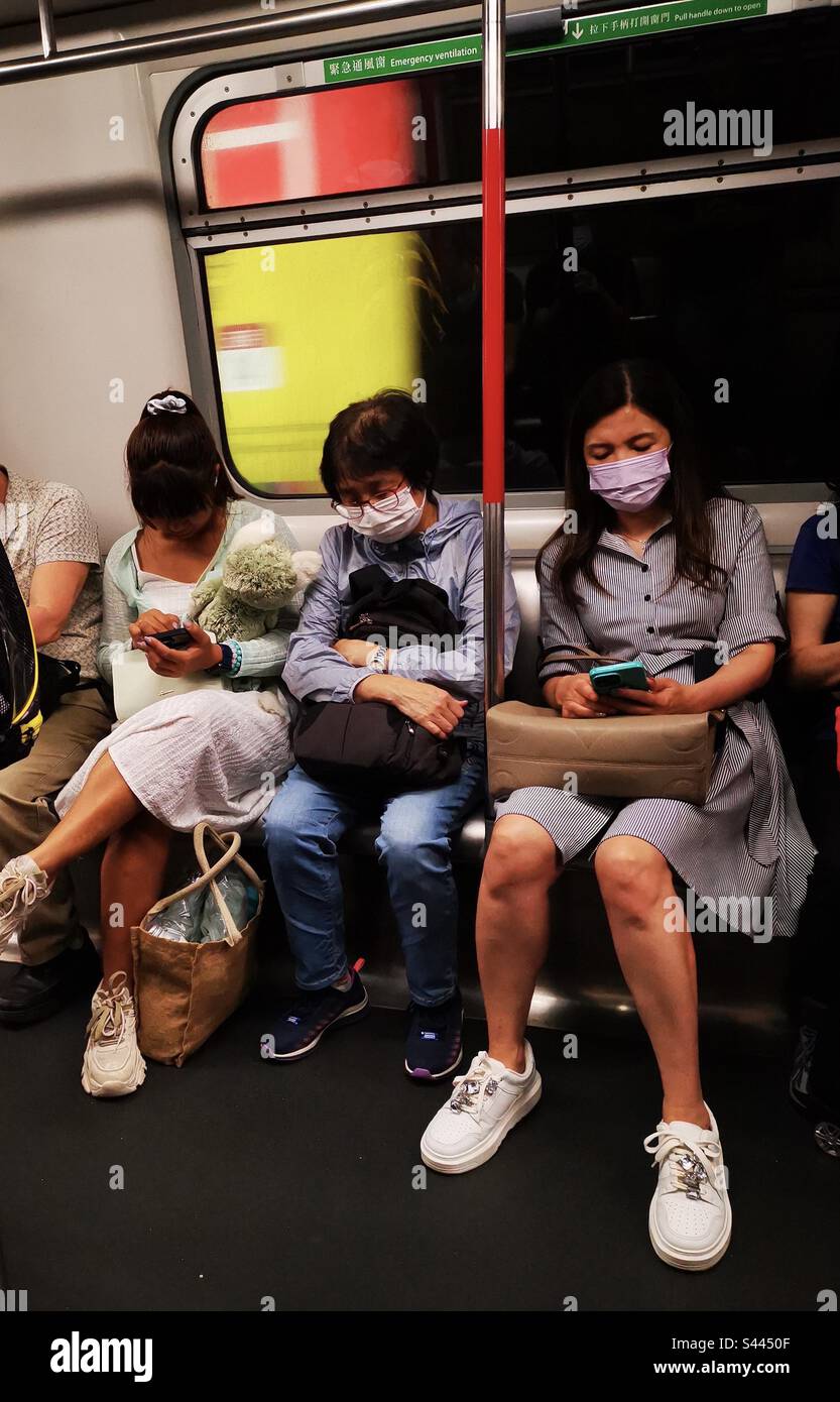 Passengers on the MTR in Hong Kong Stock Photo - Alamy