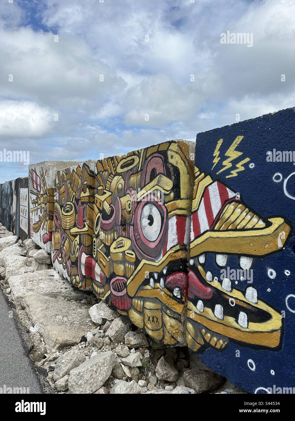 Creative graffiti painted on a cement cubic rock Stock Photo - Alamy