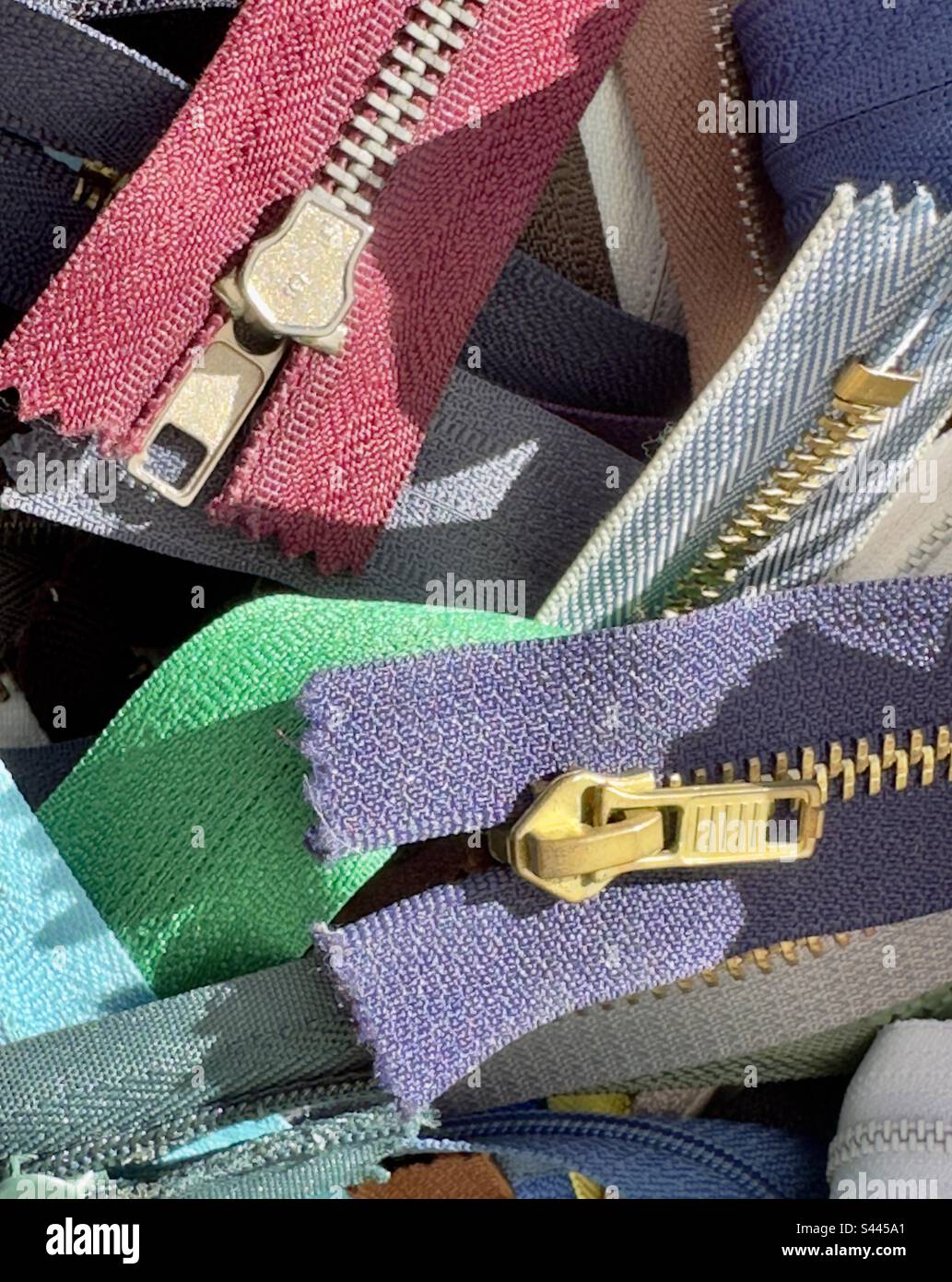 A jumble of different coloured zip fasteners for sale on a French ...