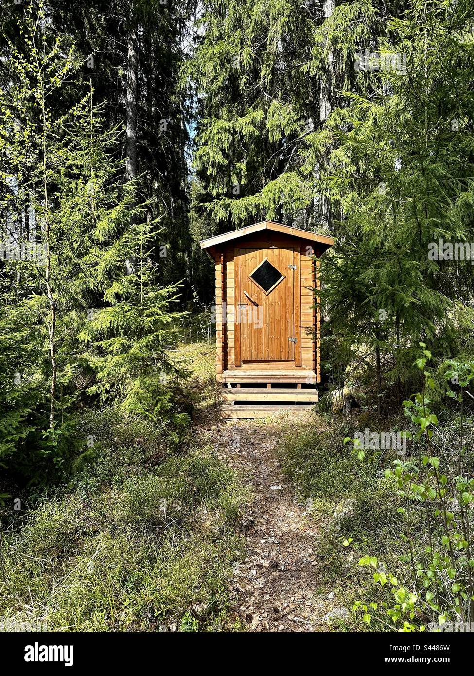 Wooden outhouse in the woods Stock Photo - Alamy
