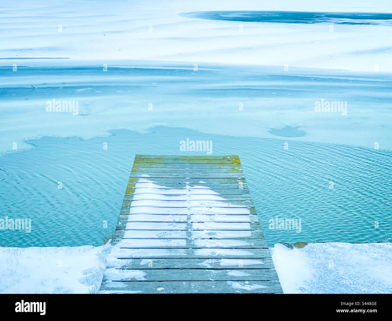 Small wooden jetty on a frozen lake Stock Photo - Alamy