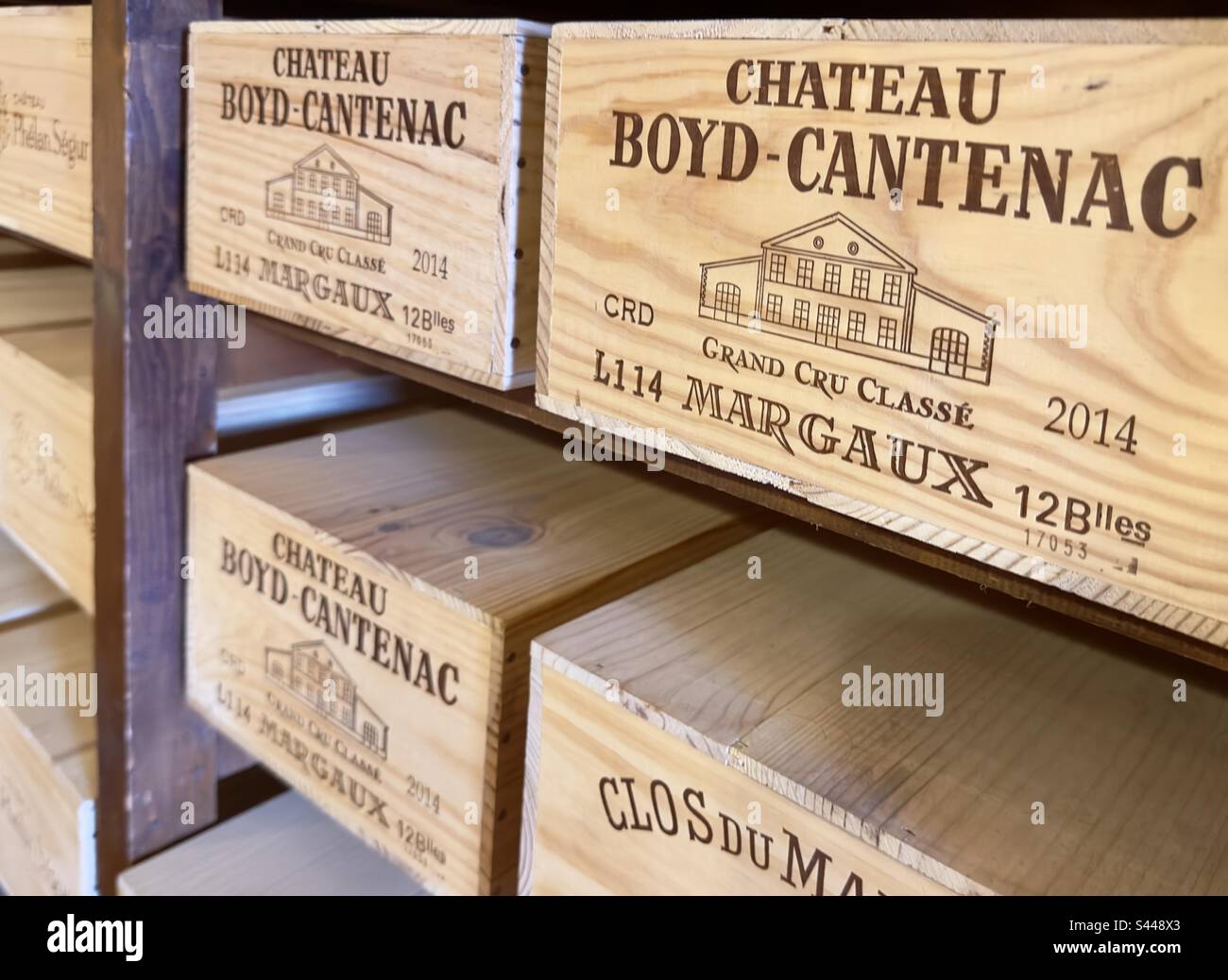 Cases of fine wine offered for sale in a French wine merchant warehouse ...