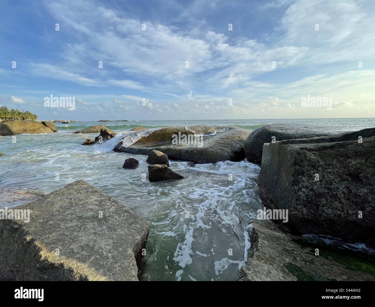 Waves crashing over rocks Stock Photo - Alamy