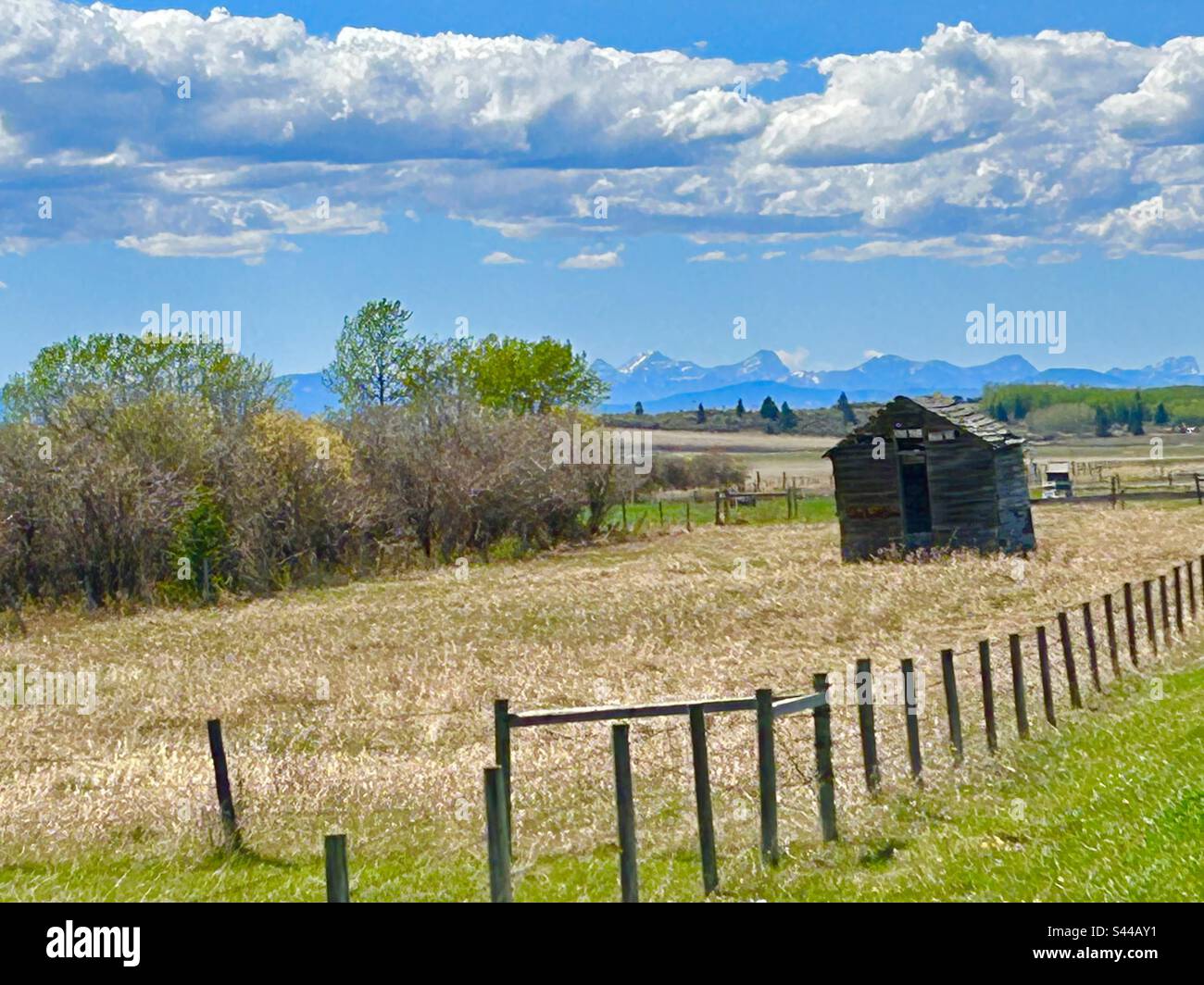 Old shed on the country, fence, posts, poles, hedge, mountains, clouds ...