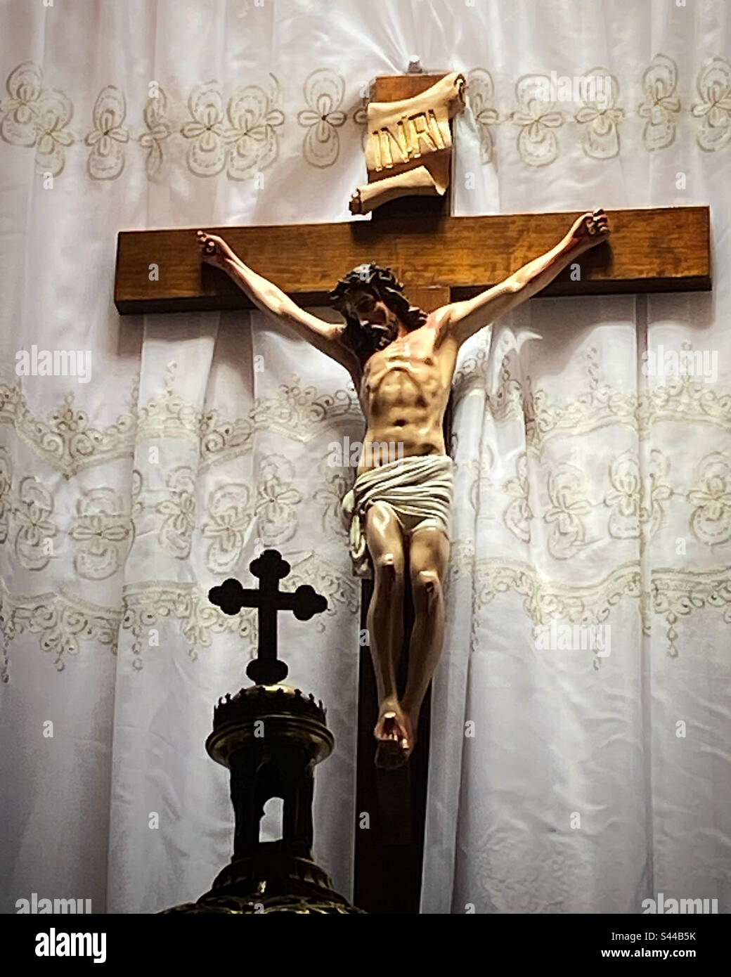 A sculpture of Jesus Christ crucified and a cross decorate a San Pedro ...