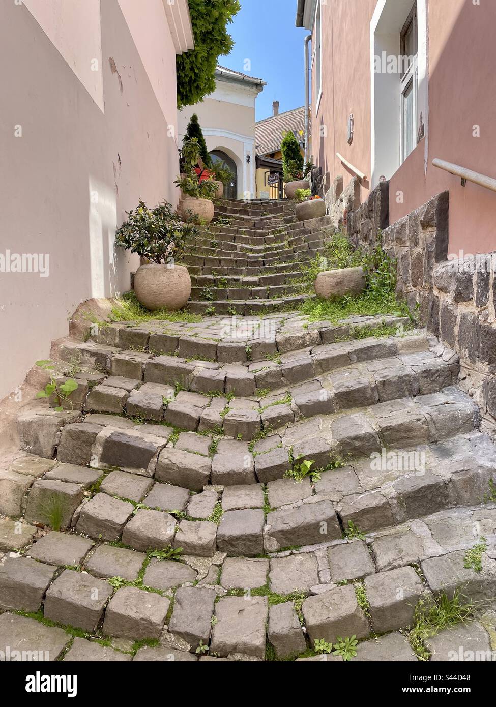 Narrow alley with crooked stairs Stock Photo - Alamy