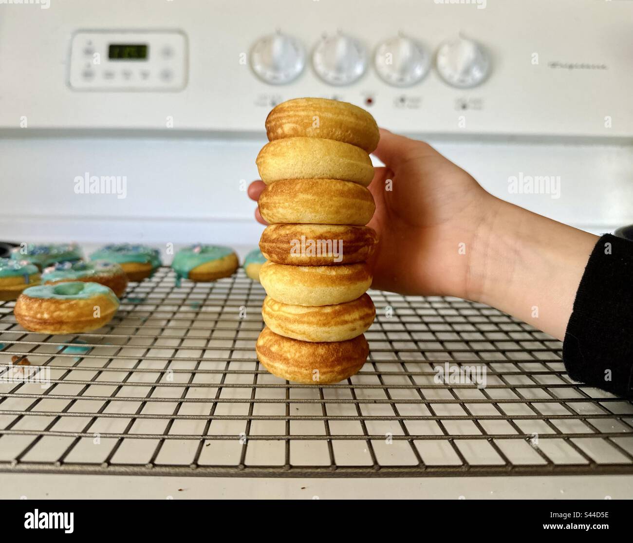 Young kid cooking donuts in kitchen Stock Photo - Alamy