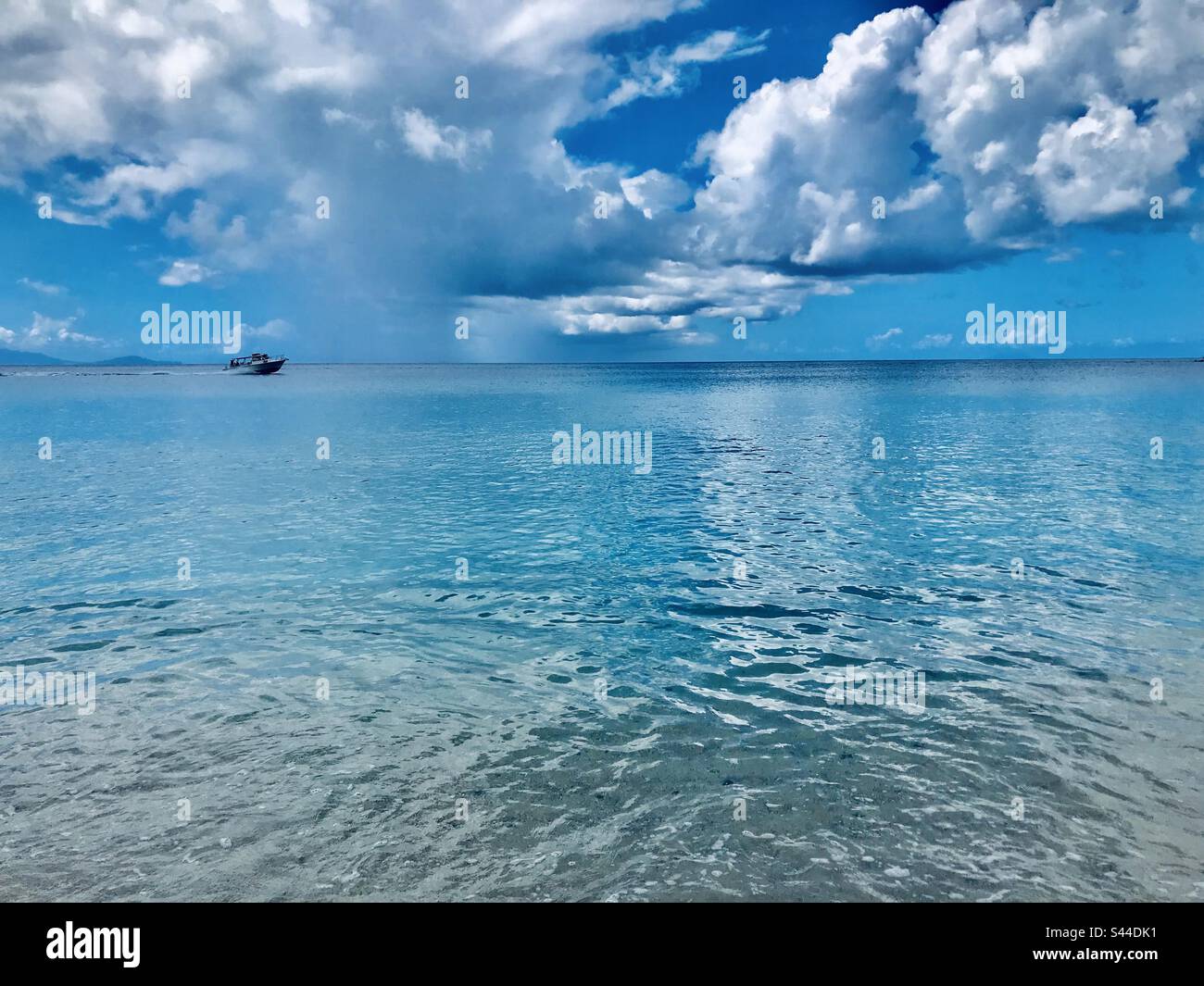 A boat in the distance on the water of the Caribbean Ocean Stock Photo ...