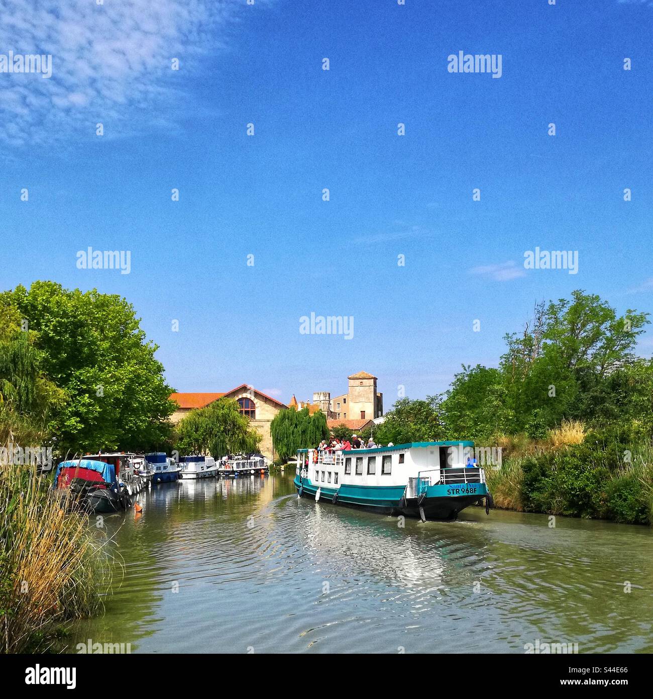 Cruising barge on the Canal du Midi. Port of Colombiers. Occitanie ...