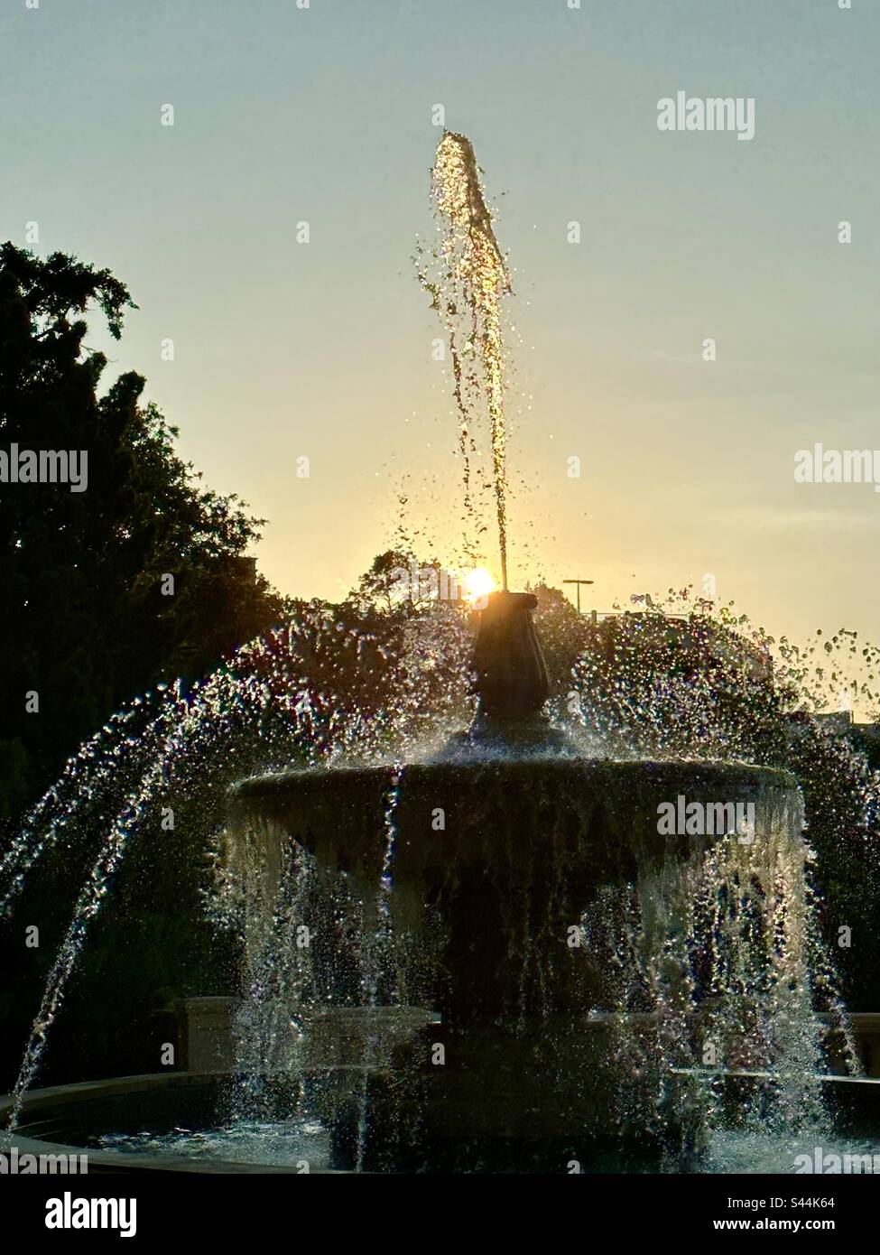 A water fountain in the sunset Stock Photo - Alamy