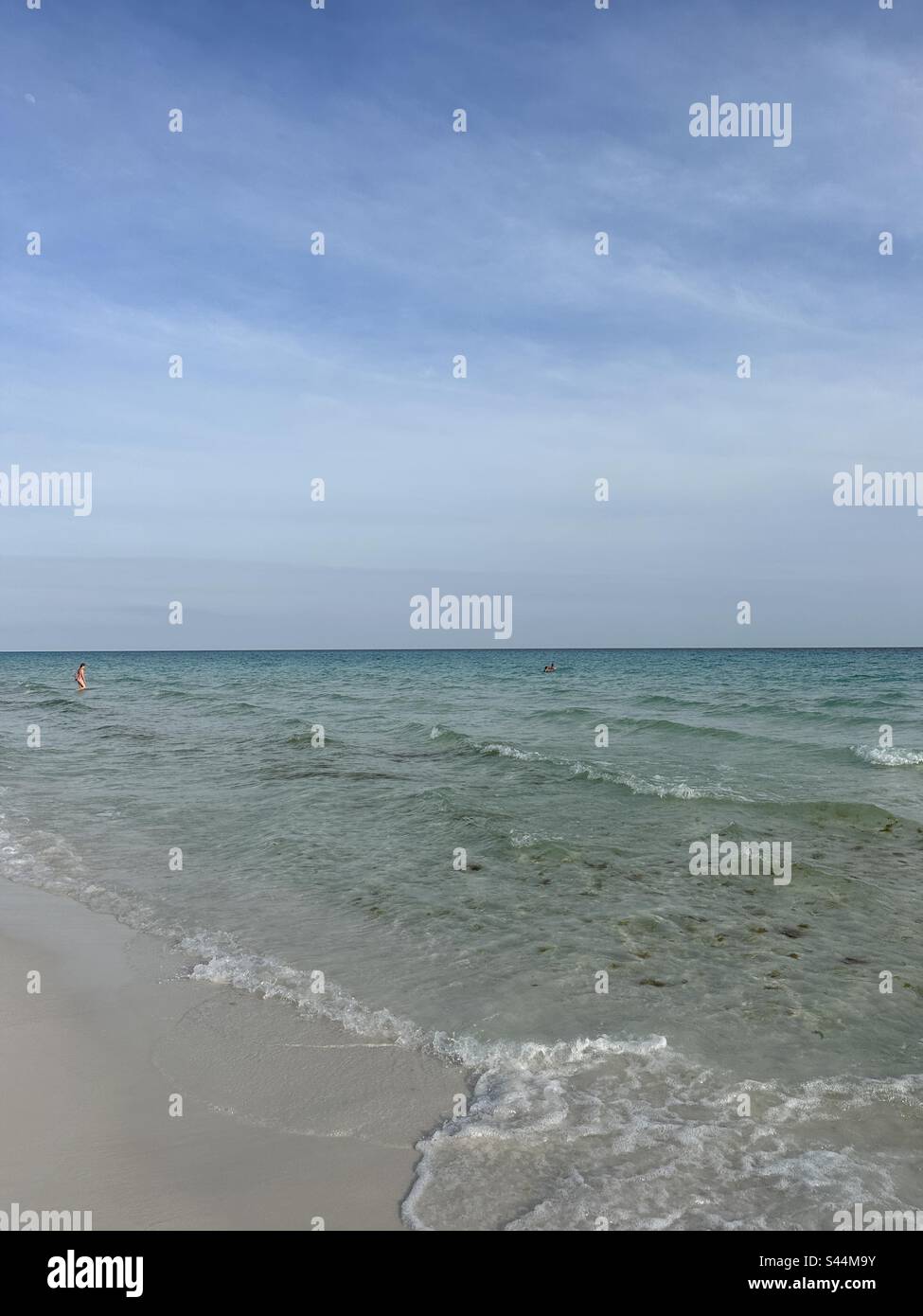 Swimmers in the Gulf of Mexico water with late evening skies Stock ...