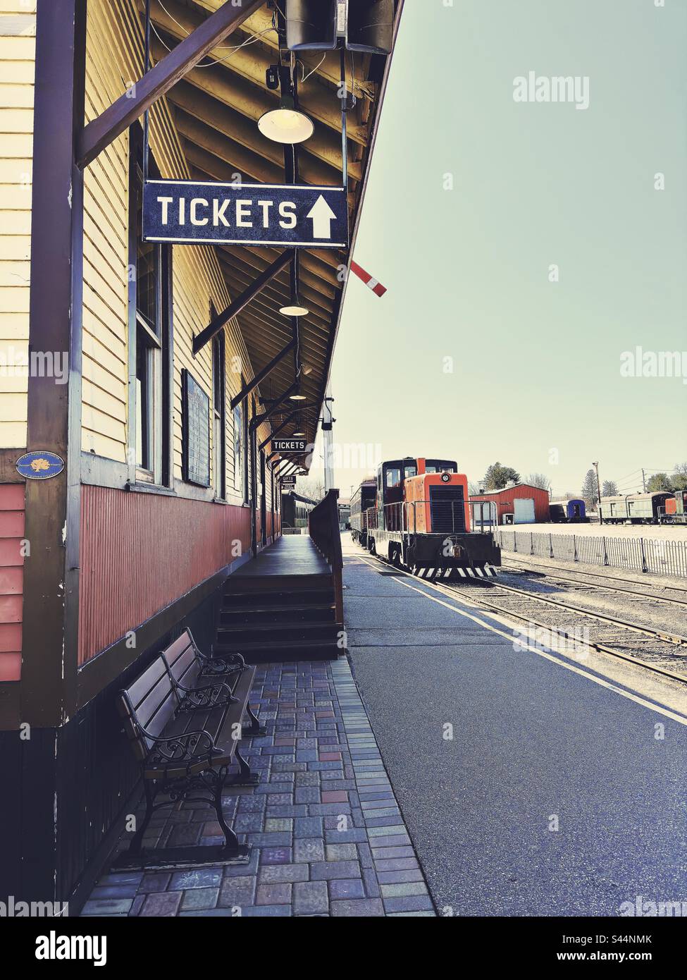 Old-fashioned train station building with sign that says tickets and an ...