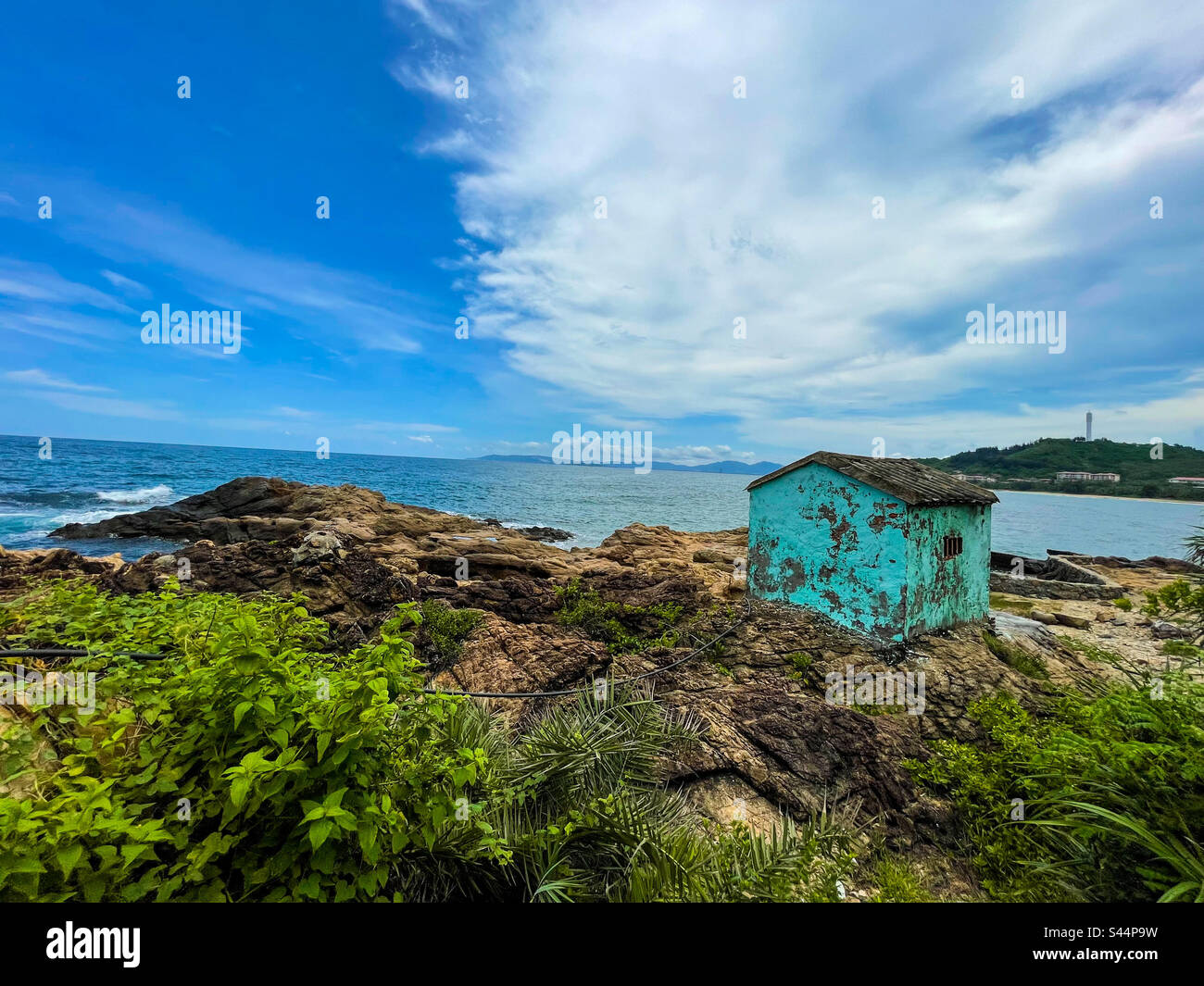 Little blue house on the rocks Stock Photo - Alamy