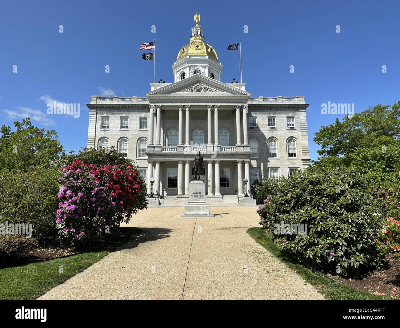 The New Hampshire Statehouse (Capitol building) on a clear, sunny day ...