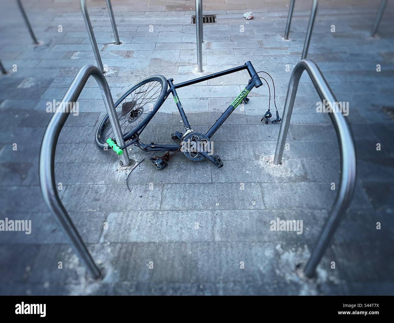 Vandalised locked bike still chained to bike rack Stock Photo - Alamy
