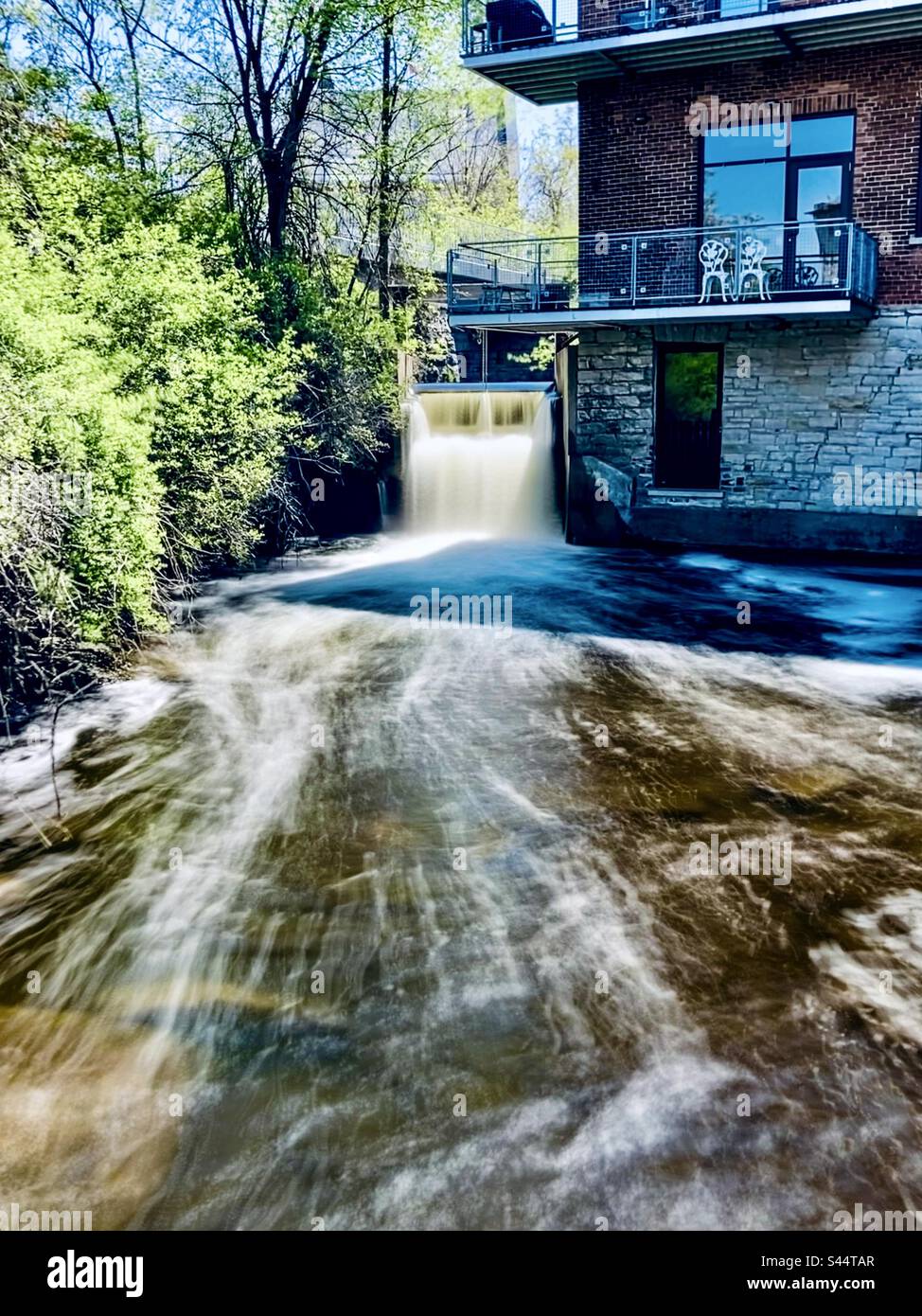 A small waterfall part of an old mill in long exposure Stock Photo - Alamy
