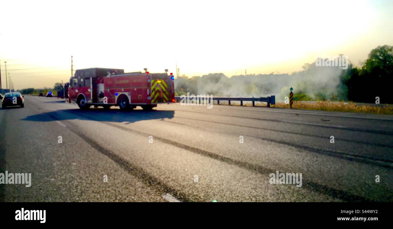 Emergency on the motorway. A fire truck, a stranded car, and smoke ...