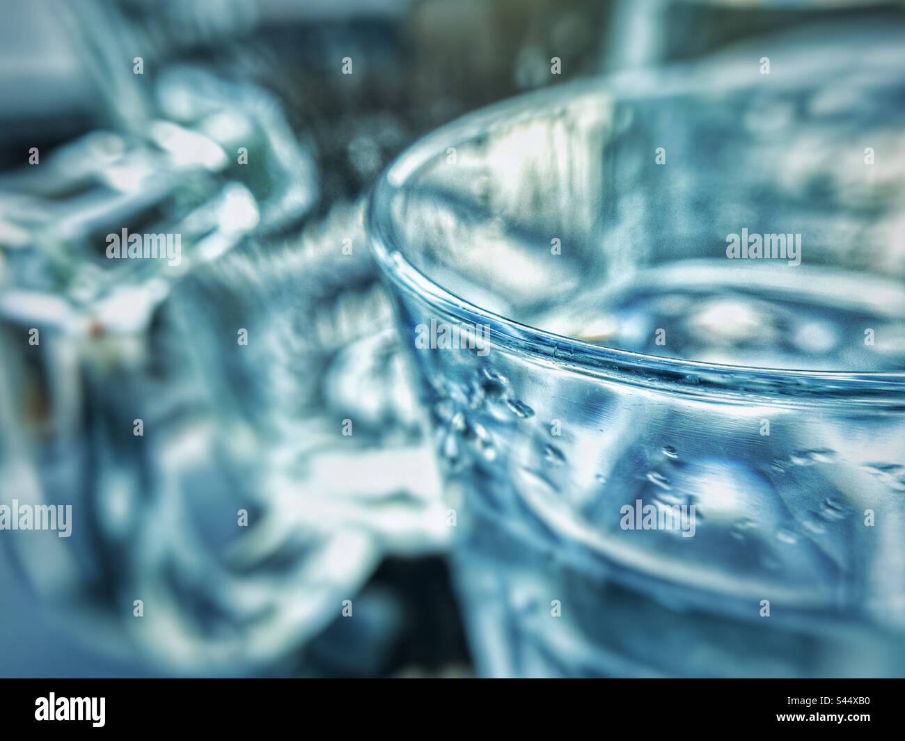 Close up of a glass of water. Macro focus emphasis on the rim of the ...