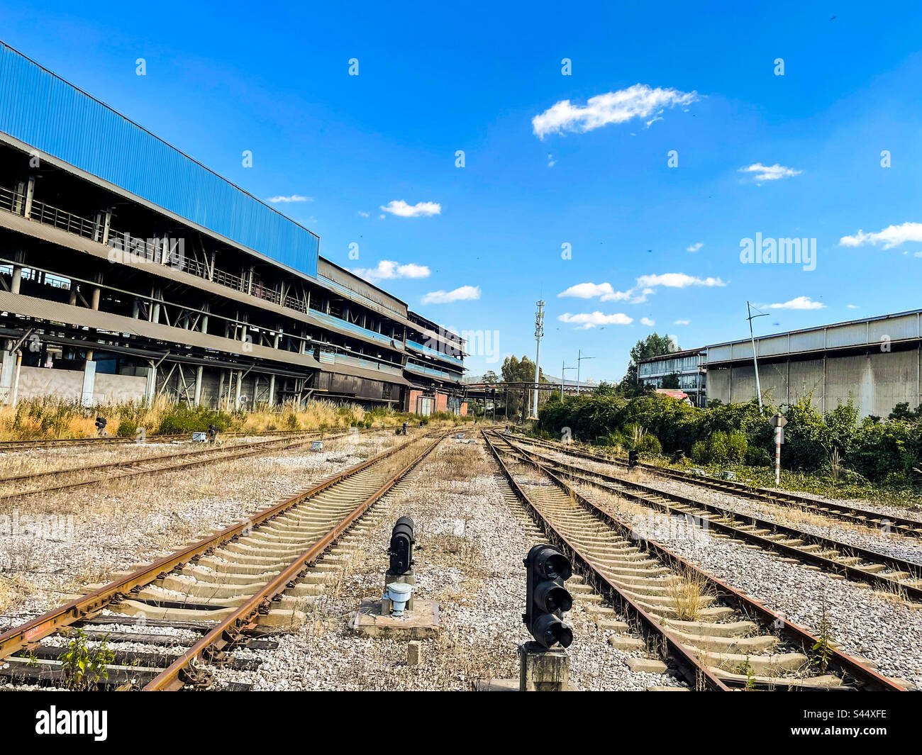 Railway tracks next to factory Stock Photo - Alamy
