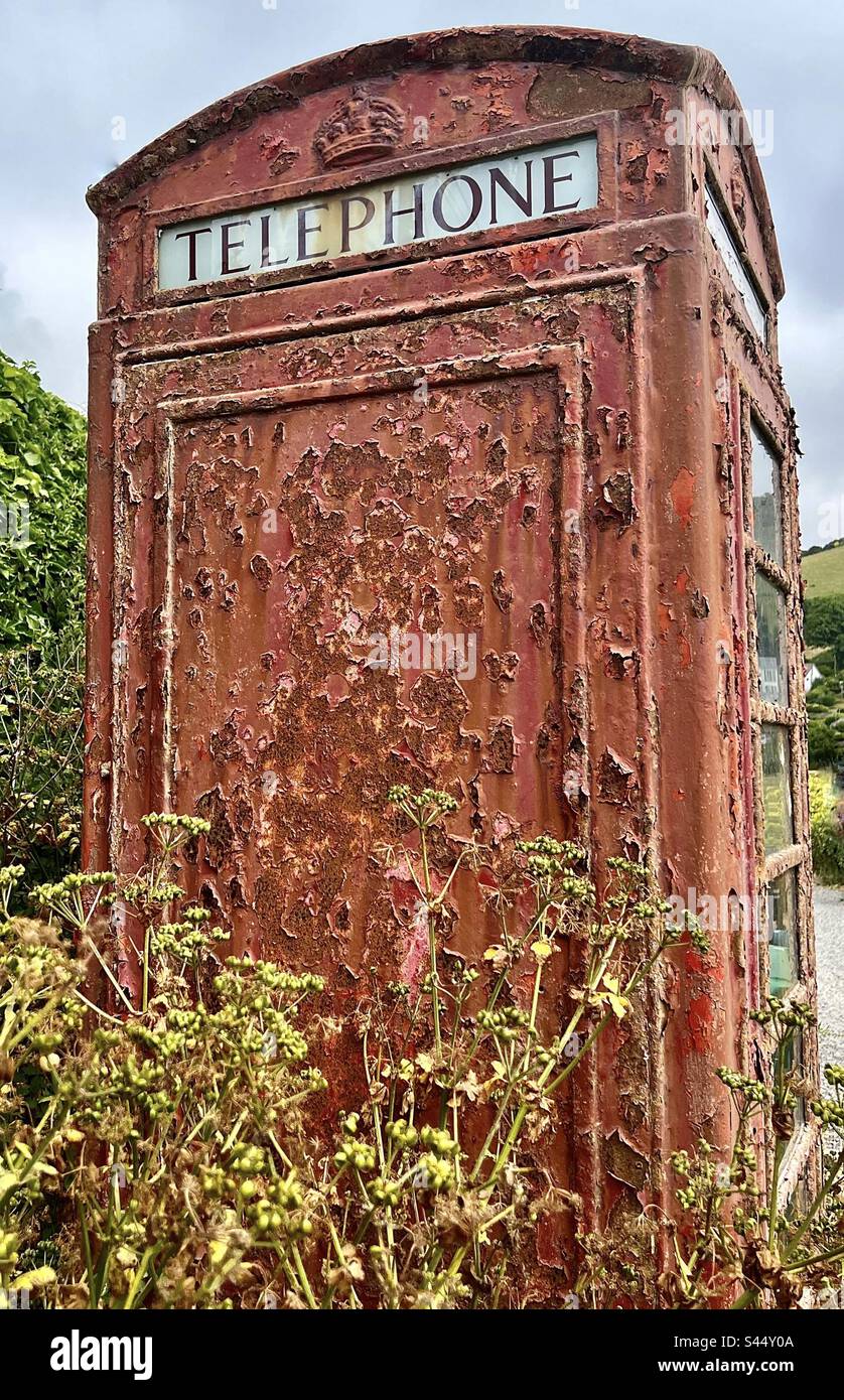 Old red telephone box with peeling by paint Stock Photo - Alamy