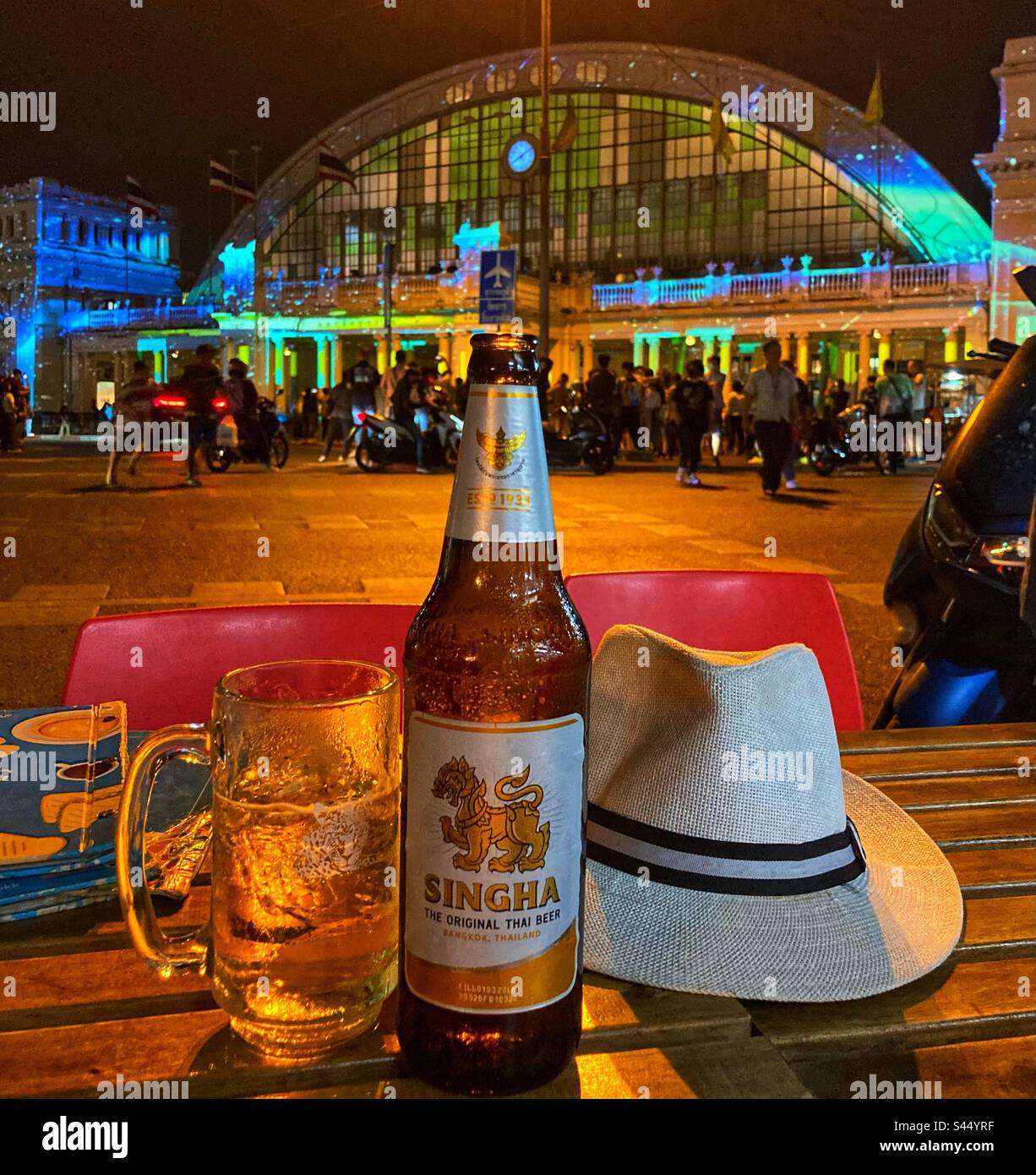 Singgah beer bottle and travellers hat looking onto Hua Lamphong train ...