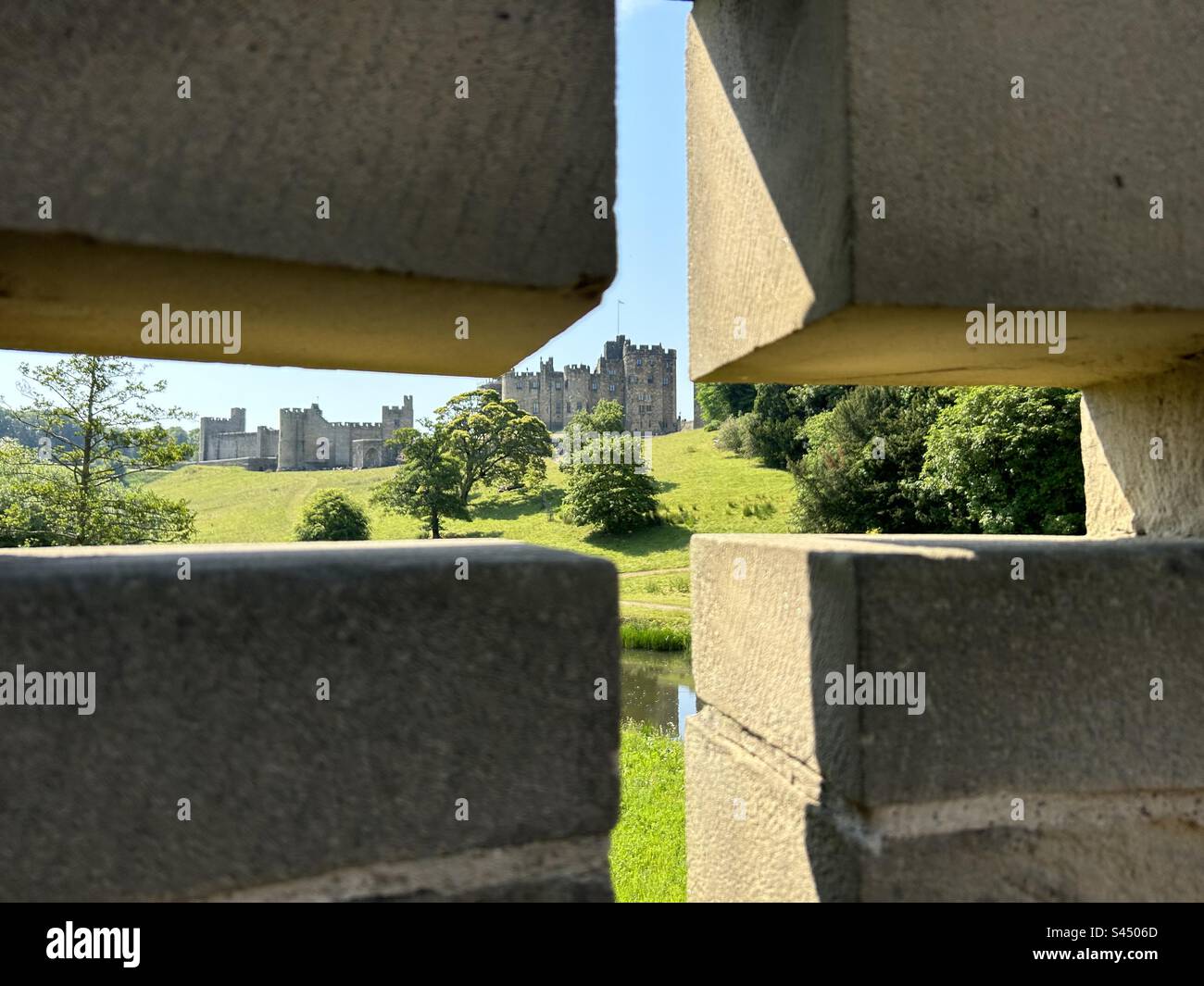 Alnwick castle photographed through a turret slit from the bridge ...