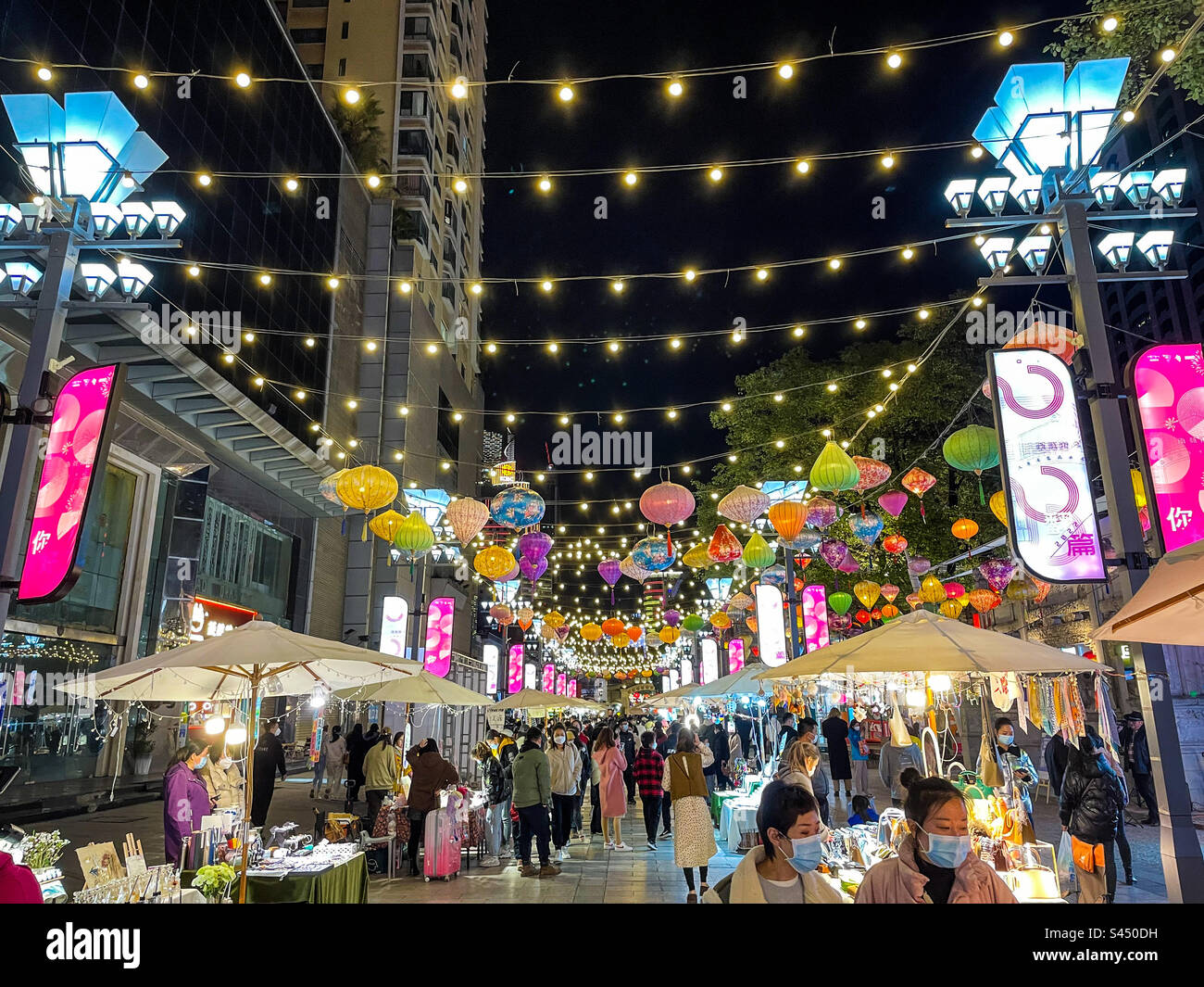 Fairy lights between restaurants Stock Photo - Alamy