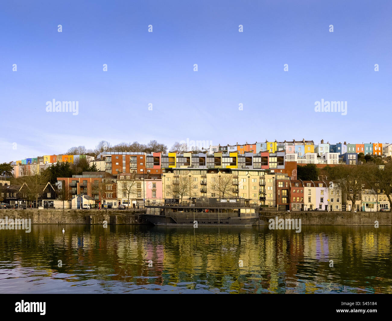 Grain Barge at sunrise seen with colourful traditional and contemporary ...