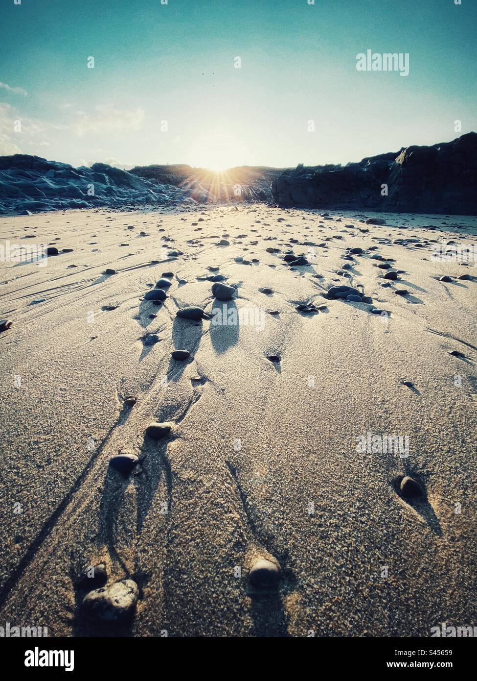 A low perspective photograph of a beautiful beach scene at sunrise ...
