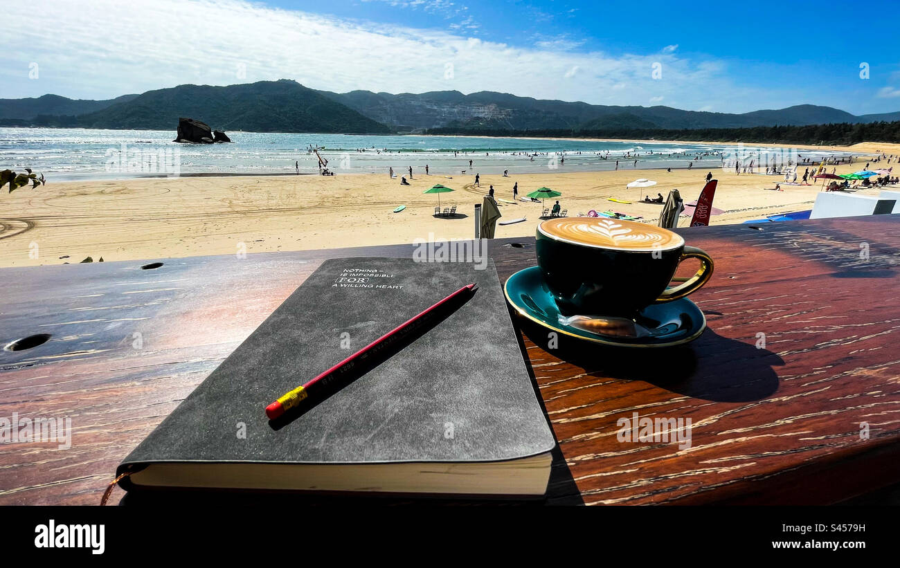 Coffee and notebook at the beach Stock Photo - Alamy