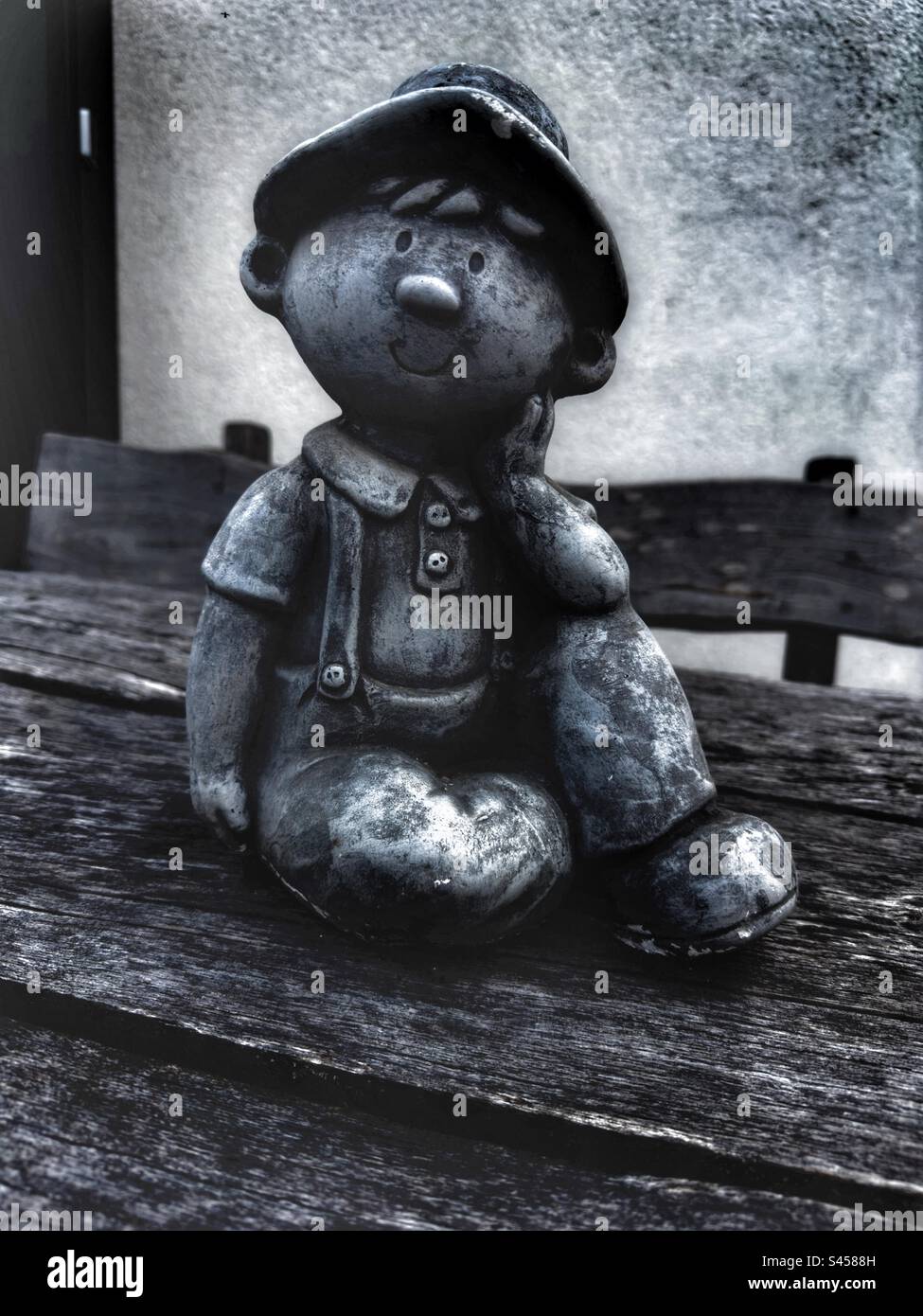 Boy stone statue sitting and smilling Stock Photo - Alamy