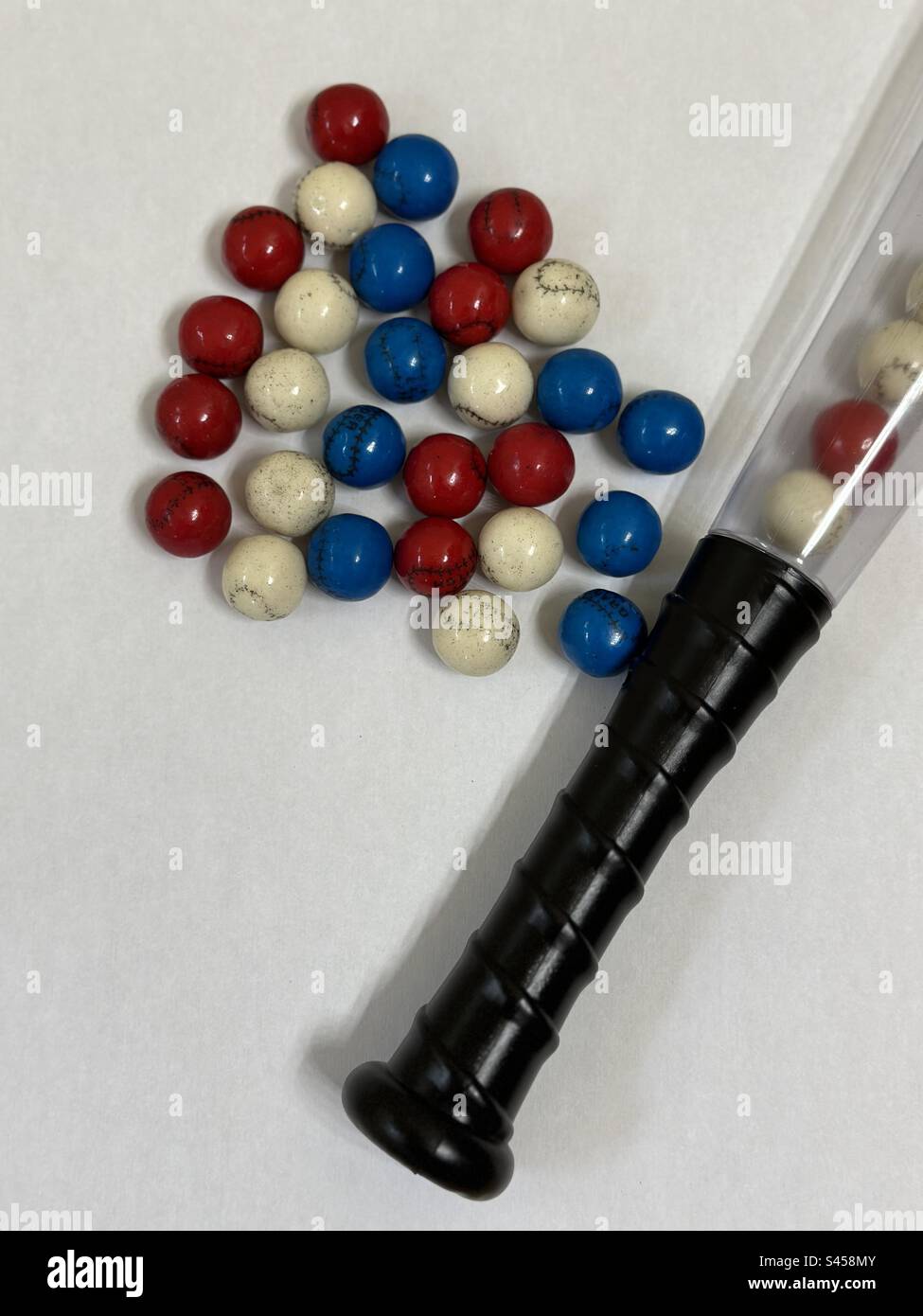 Red, white and blue gum balls with a bat Stock Photo - Alamy