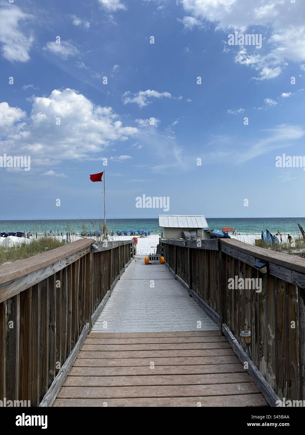 Wooden walkway to Florida white sand beach with Gulf of Mexico water ...