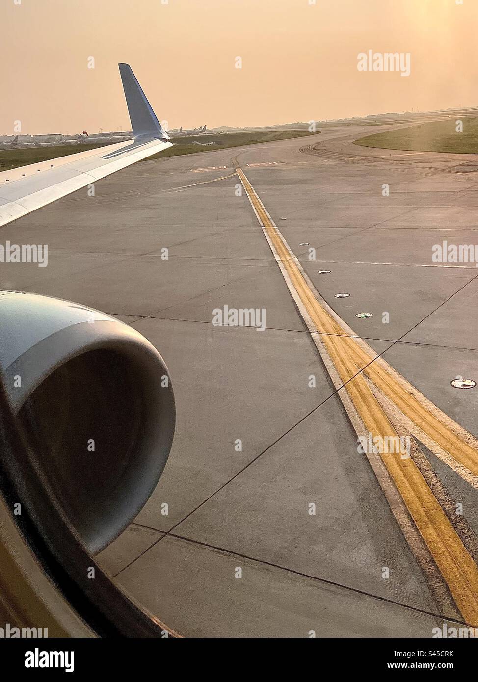 Sunrise on the runway, runway markings leading to new horizons, engine ...